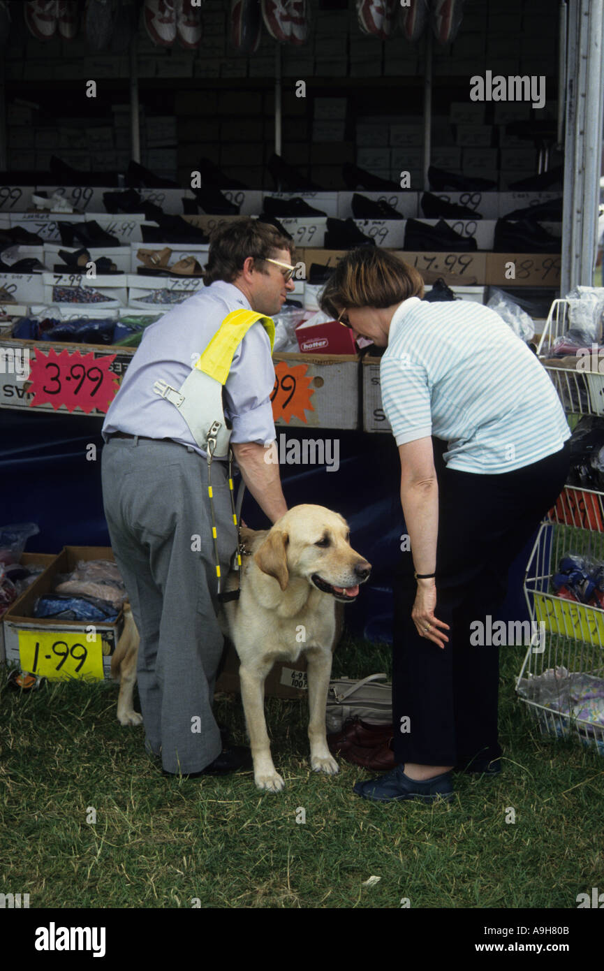 People Animals blind man with guide dog at stall Stock Photo - Alamy