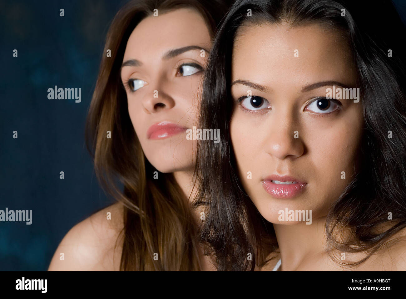 two brunette models with focus on one and serious expressions Stock ...