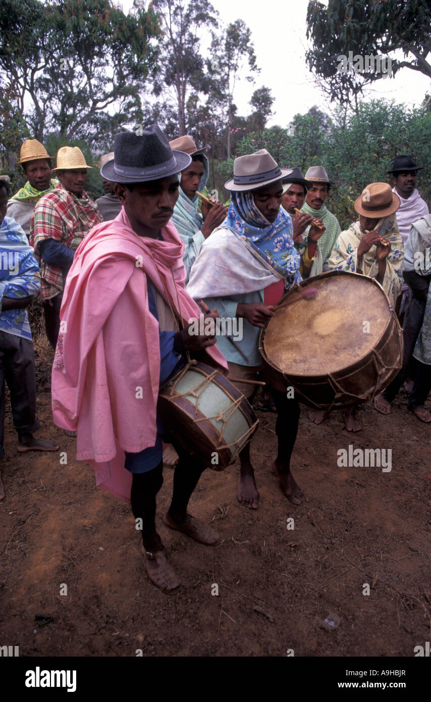 Musicians cheerfully plays while relatives of the death dance with the ...