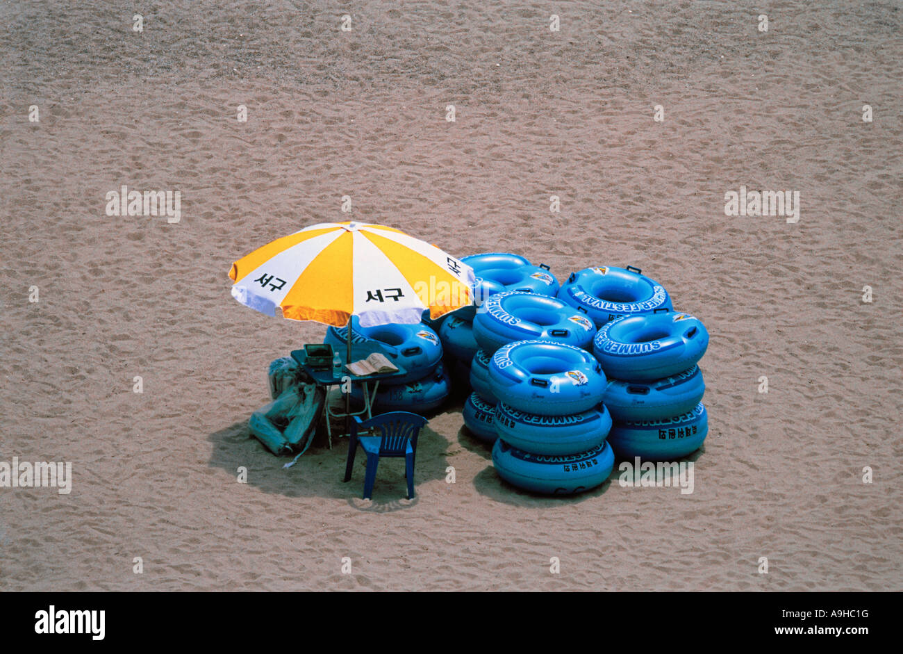 Floating Tires and Parasol at the Beach Stock Photo - Alamy