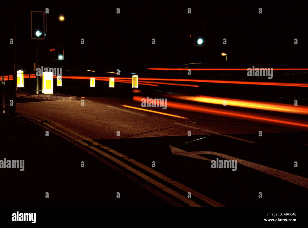Night road scene showing blurred streaks of light from passing traffic ...
