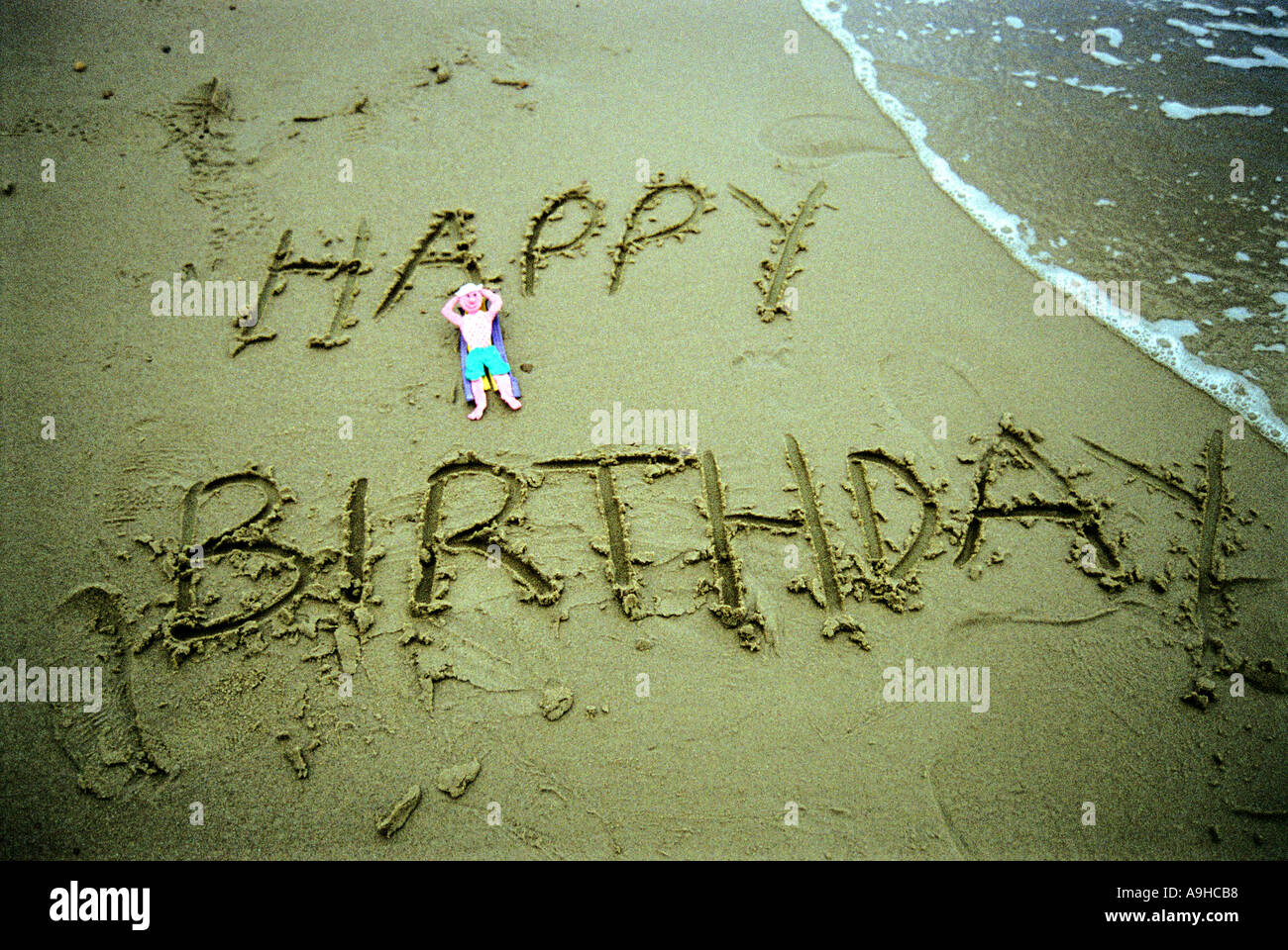 Happy Birthday Written In The Sand On Beach With Plasticine Figure On