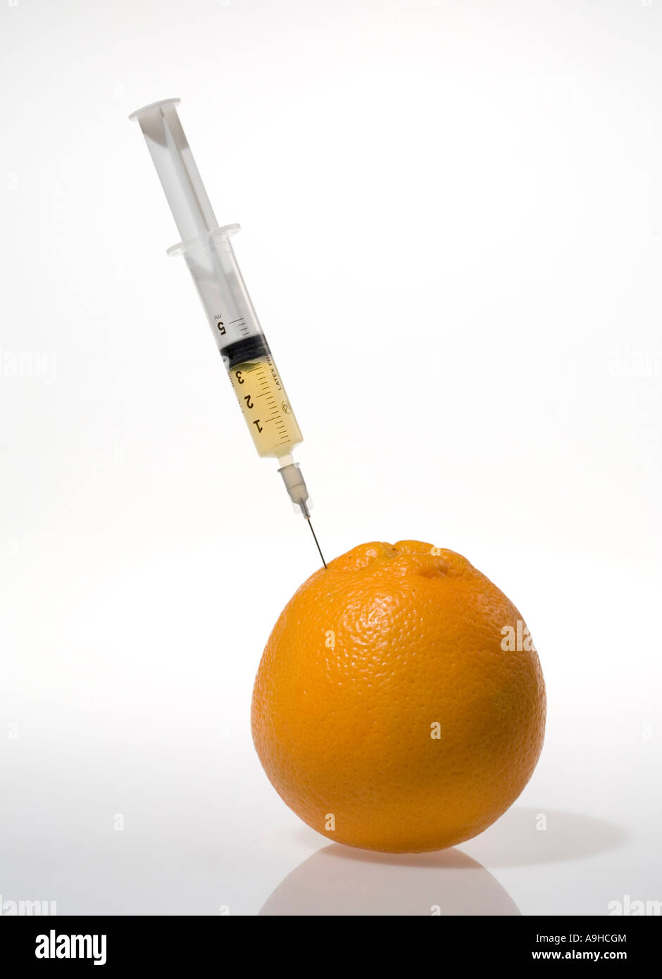 Orange with hypodermic needle Stock Photo - Alamy