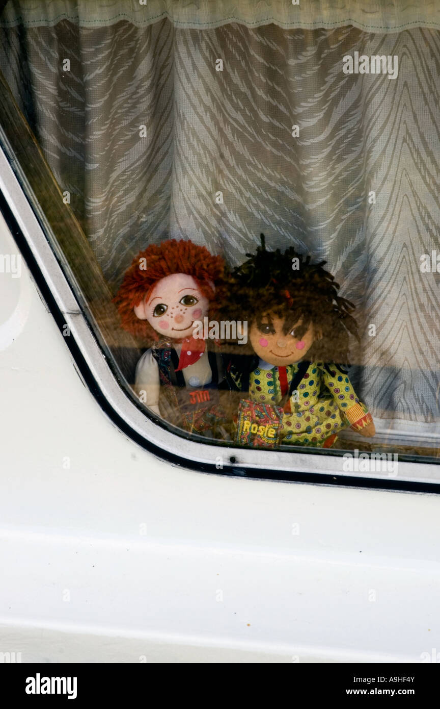 Two Dolls look out from a canal barge window on the Monmouth and Brecon ...