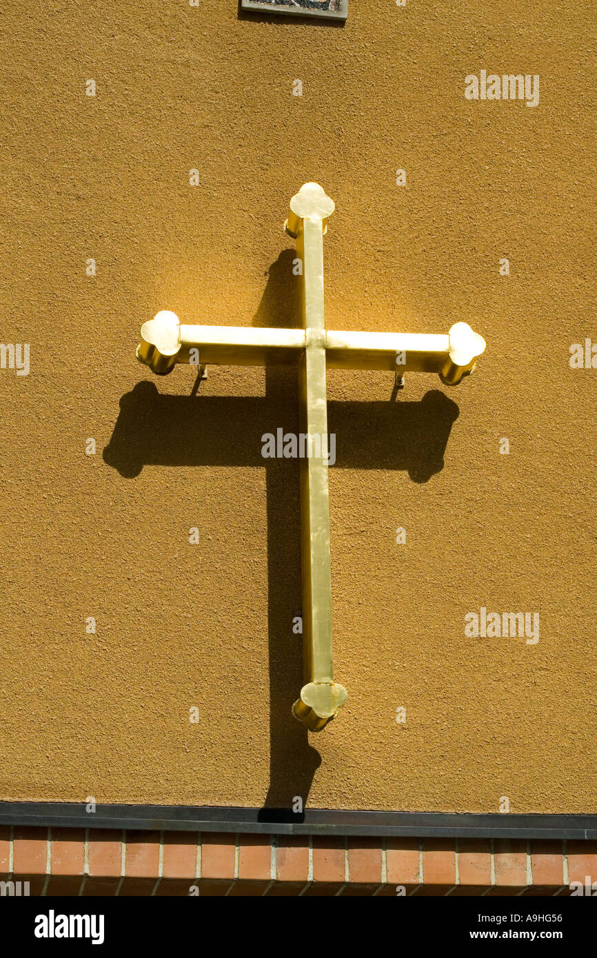 golden cross on church wall Stock Photo - Alamy