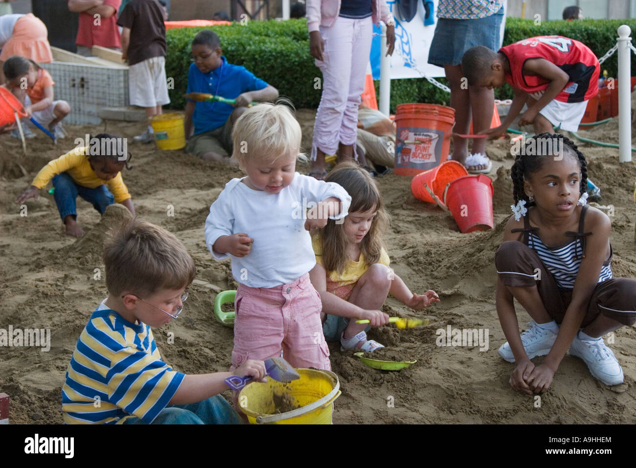 Detroit Michigan Children play in a big pile of sand during the Detroit ...