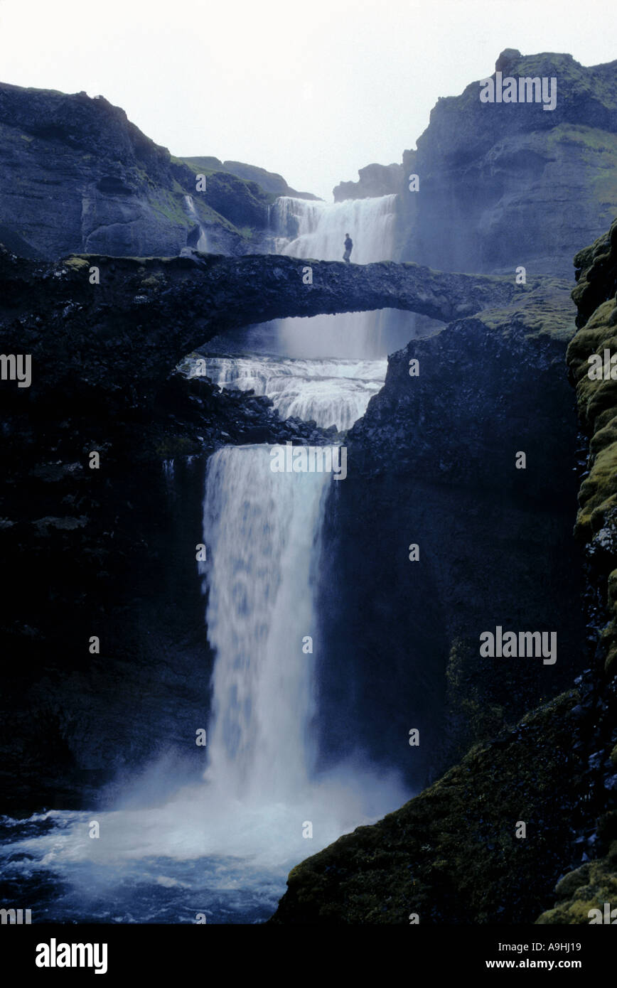 The natural basalt arch spanning the waterfall of Ofaerufoss, Iceland ...