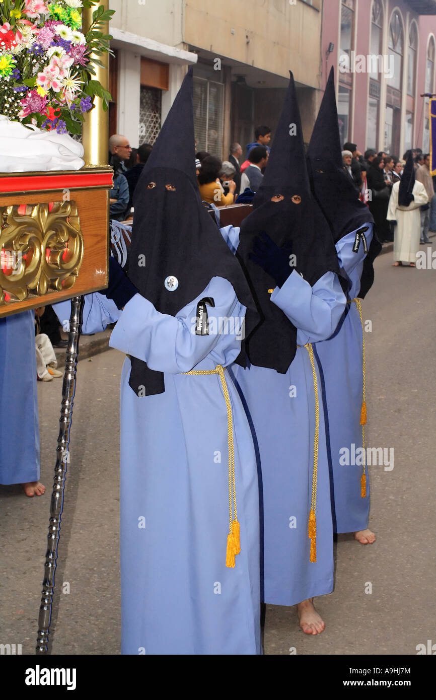 Group of men in penitence costume carrying a religious litter during a ...