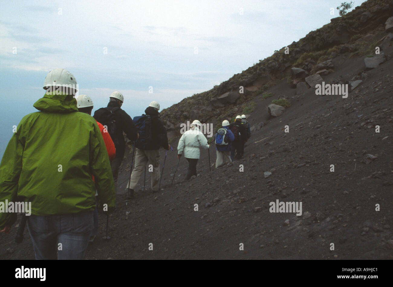 Walkers with volcanologist guide climbing Stromboli Volcano on island ...