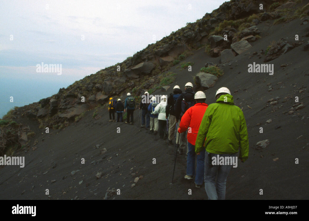 Walkers with volcanologist guide climbing Stromboli Volcano on island ...