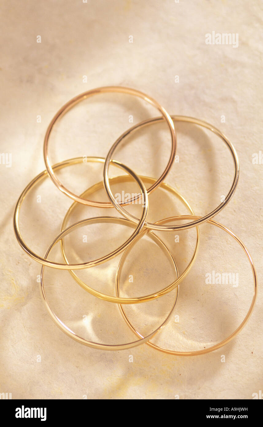 Still life of real gold bangles placed in a harmonious intertwined ...
