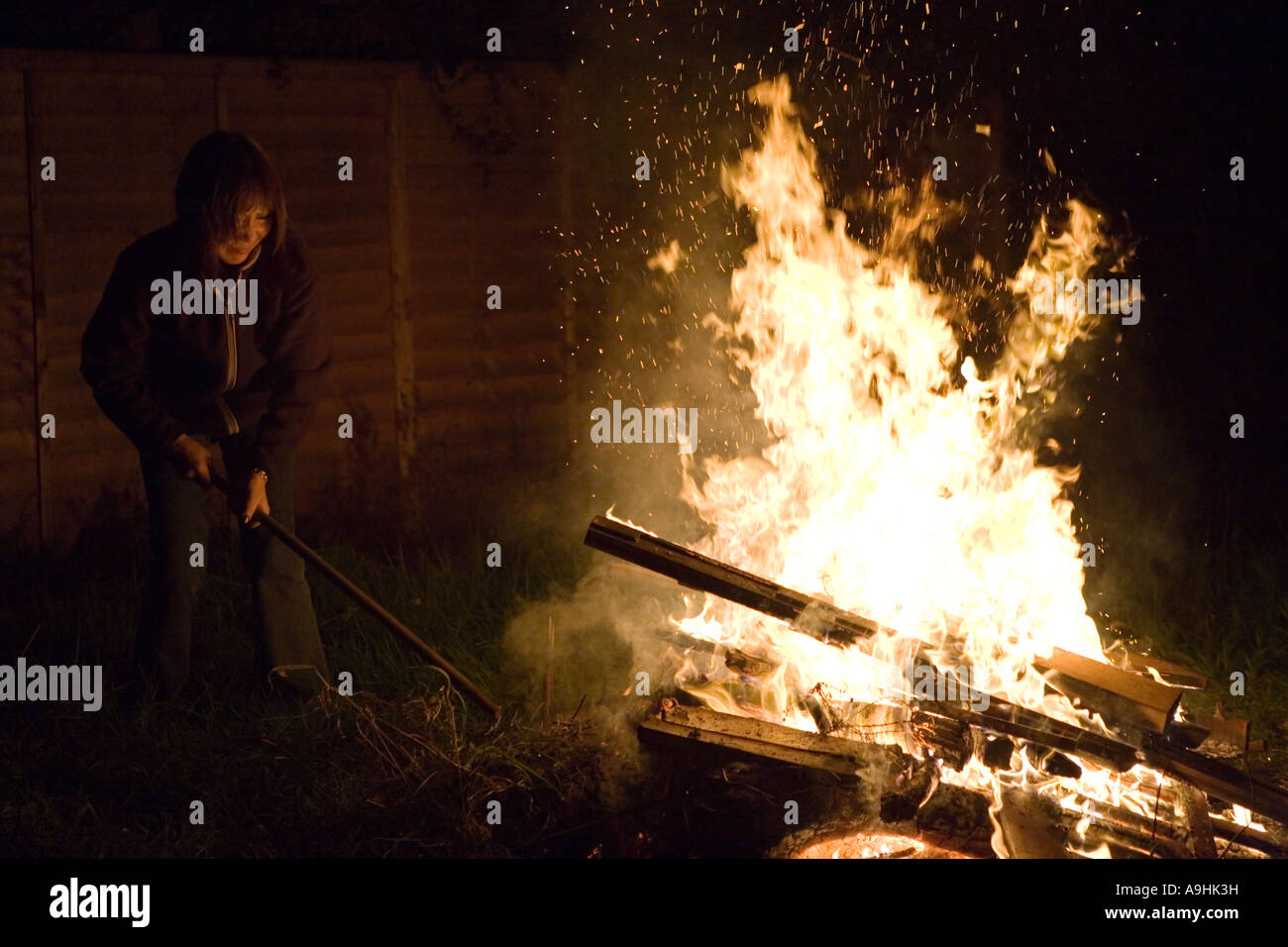 Putting wood on fire outdoors hi-res stock photography and images - Alamy