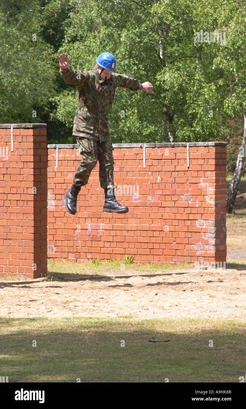 Soldier jumping off a wall on an obstacle course Stock Photo - Alamy
