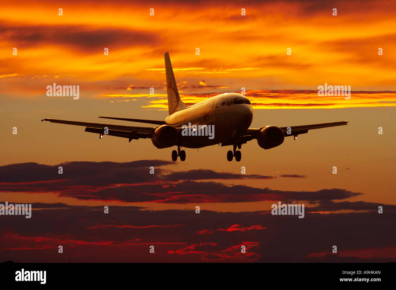 Airplane taking off into a sunset Stock Photo - Alamy