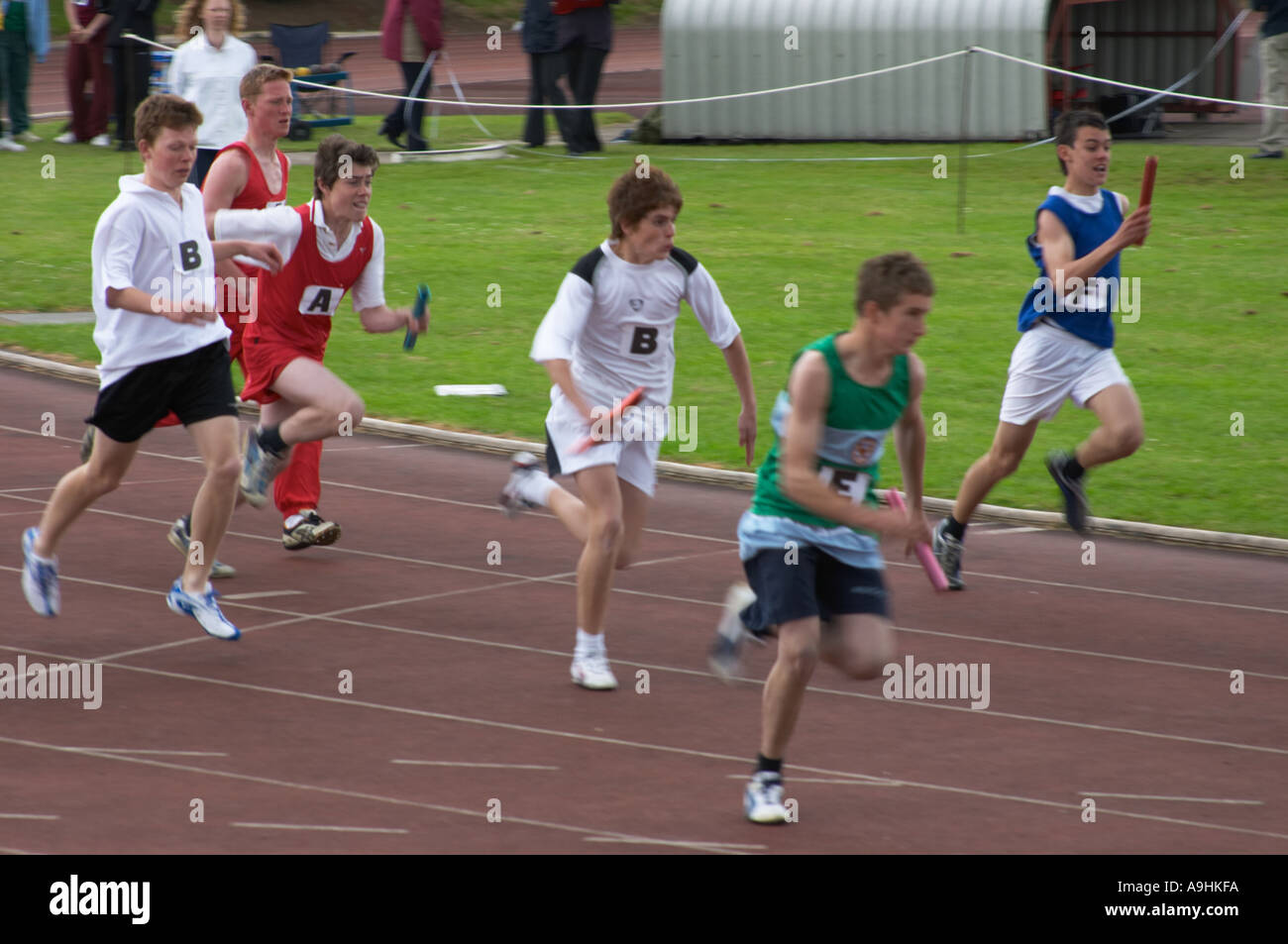 Young male athletes in relay race Stock Photo - Alamy