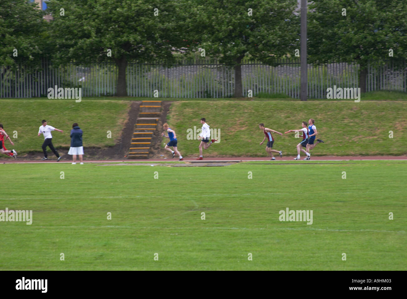 Young male athletes in relay race Stock Photo - Alamy