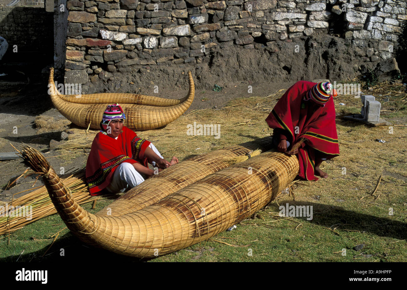 Ayamara men building reed boat called balsa de totora, Lake Titicaca ...