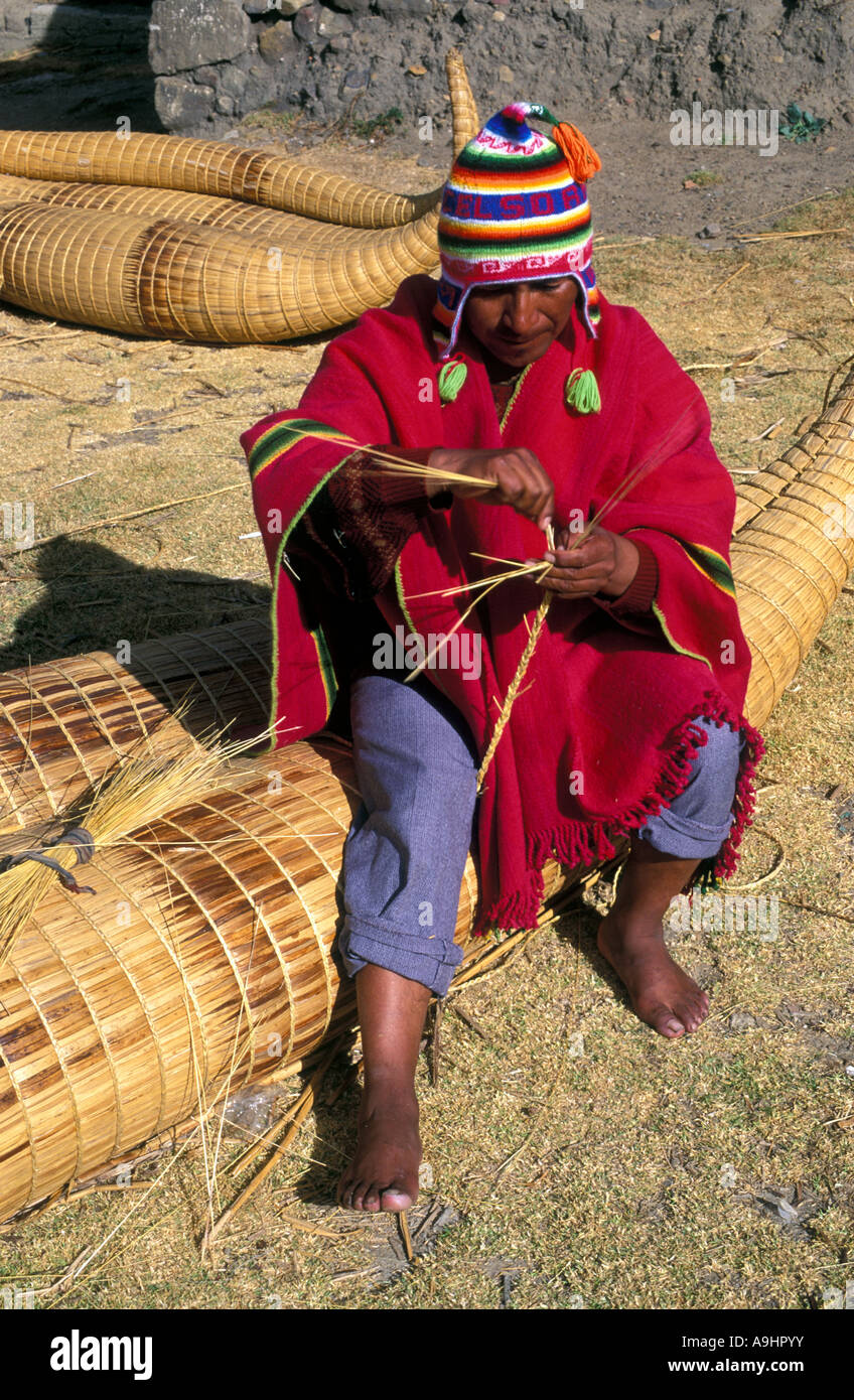 Ayamara man crafting reed boat called balsa de totora, Lake Titicaca ...