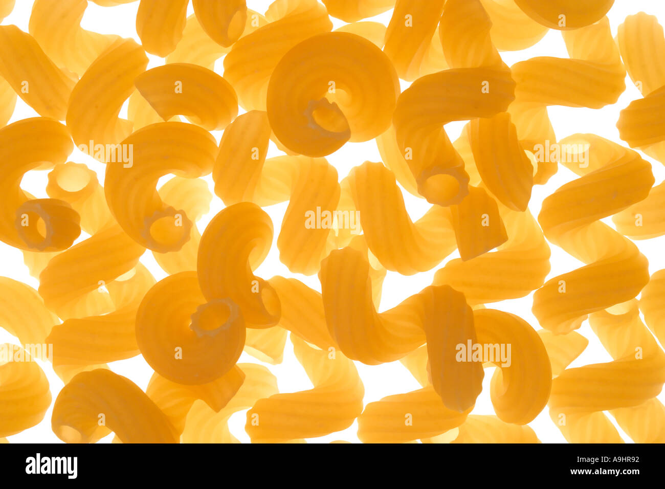 Pasta shapes backlit on white background Stock Photo - Alamy