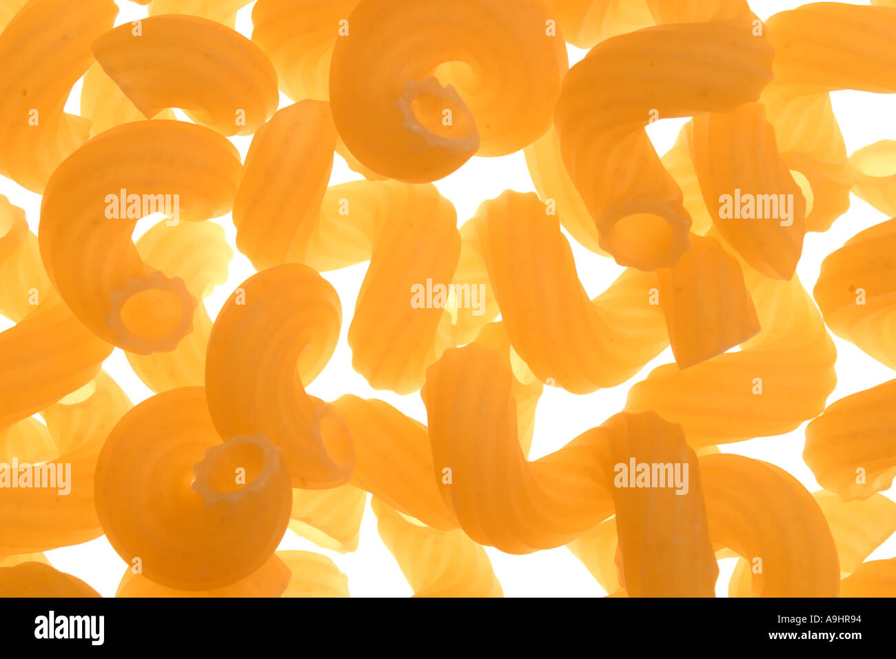 Pasta shapes backlit on white background Stock Photo - Alamy