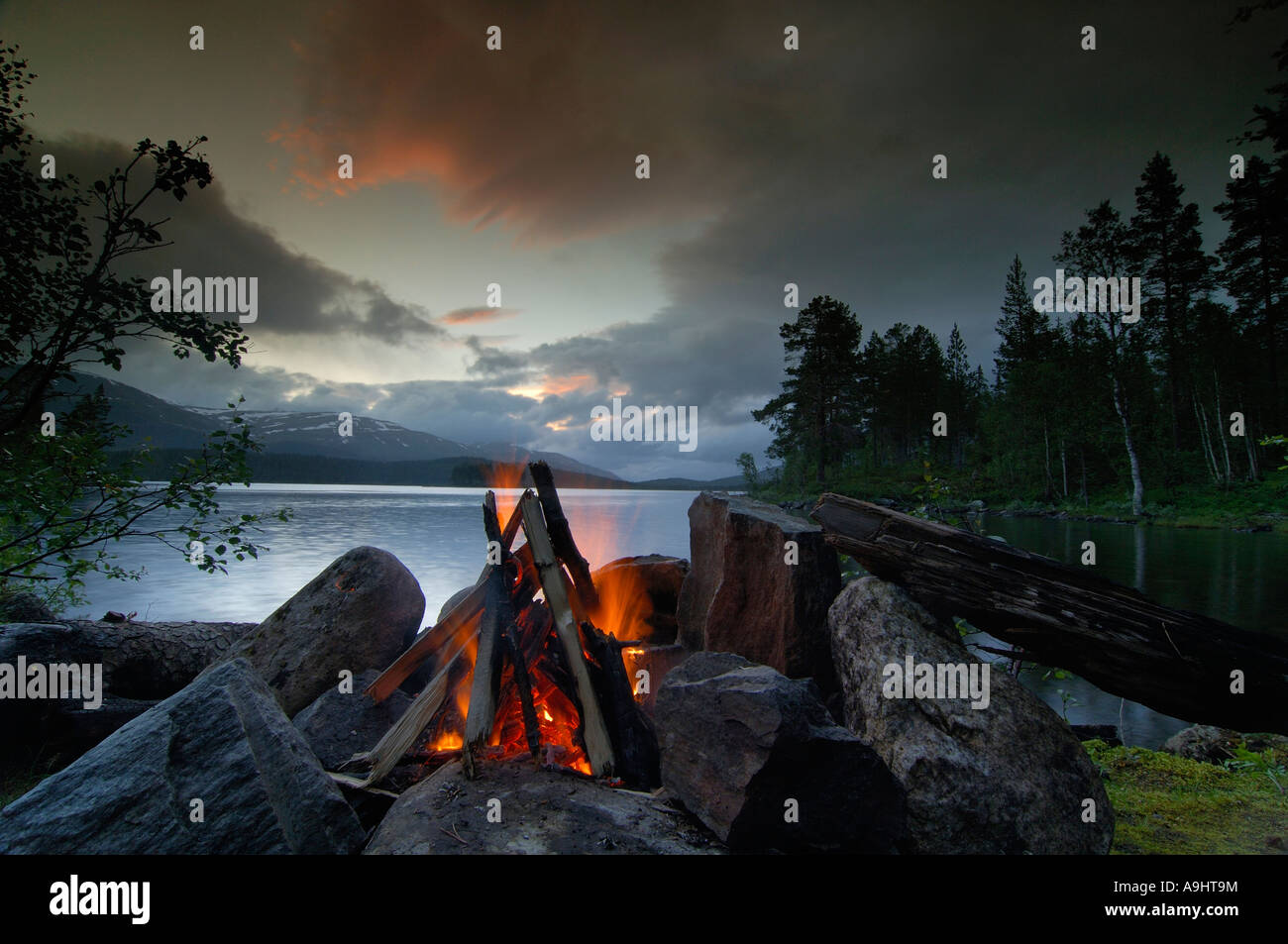 Campfire by lake Stock Photo - Alamy