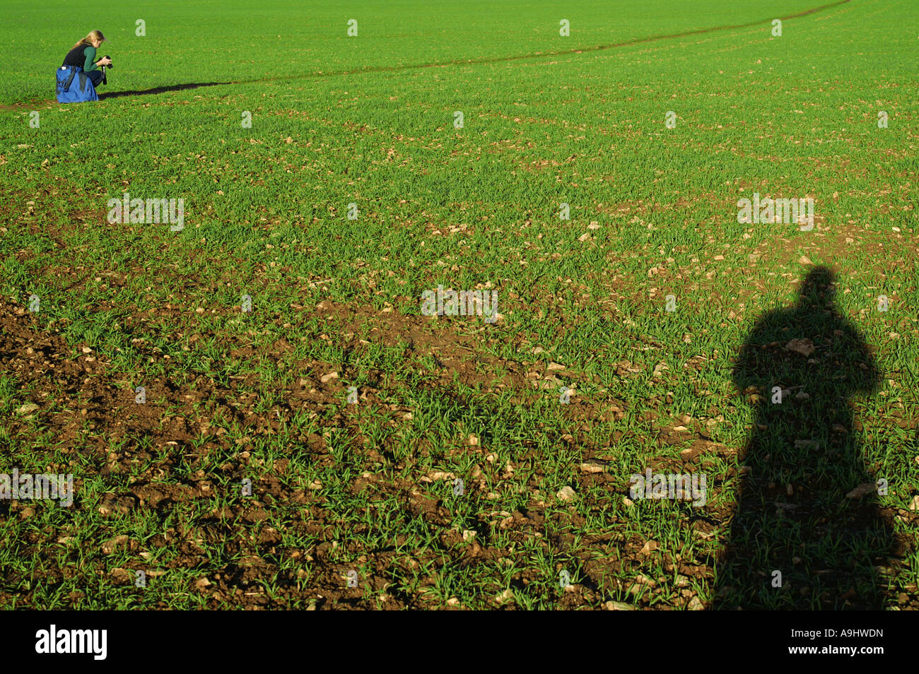 man is creeping at back of girl to take picture Stock Photo - Alamy