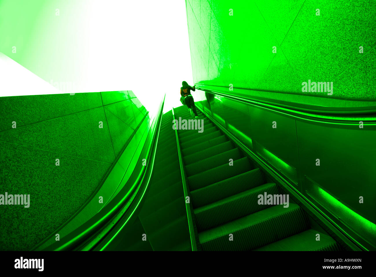Person climbing escalator hi-res stock photography and images - Alamy
