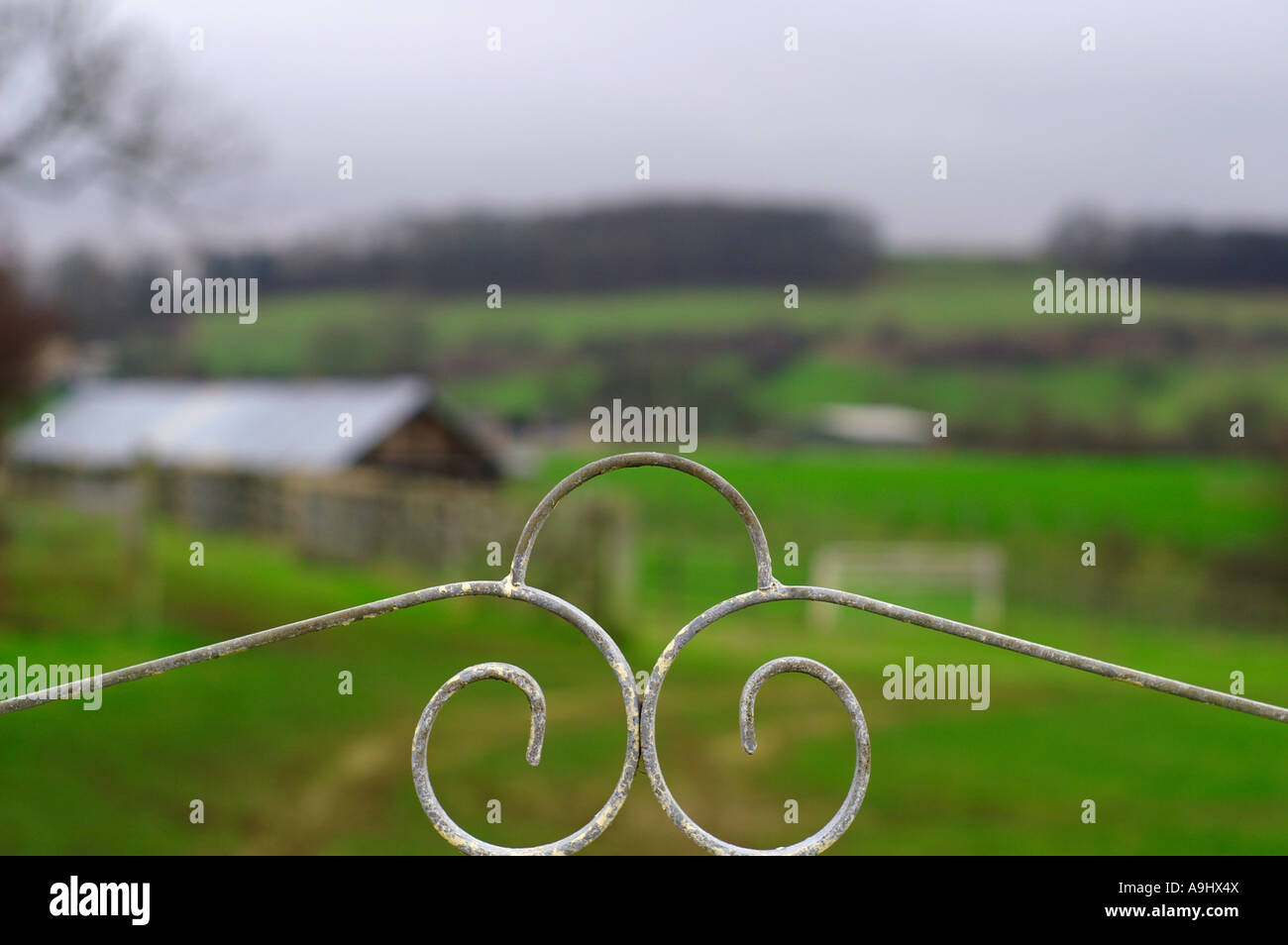 white metal gate with fuzzy countryside in background Stock Photo - Alamy