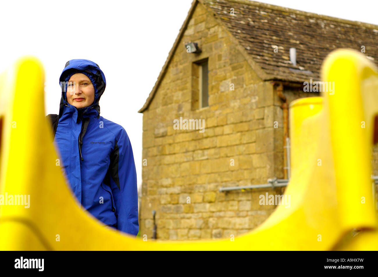 yellow slide and sceart girl in background Stock Photo - Alamy