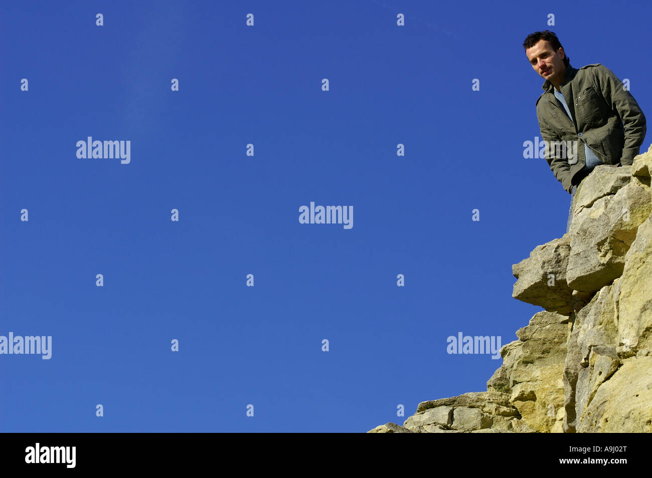 Man on the edge looking into precipice Stock Photo - Alamy