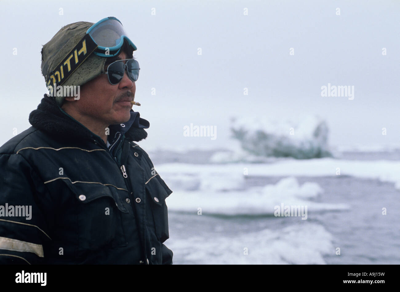 USA Alaska Yupik Eskimo Joseph Henry stands on sea ice during spring ...