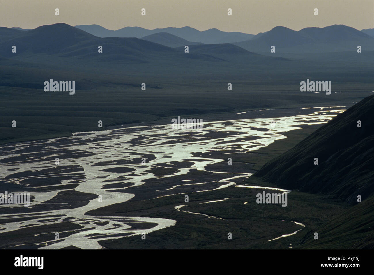 USA Alaska Summer sun reflects off Kongakut River in Arctic National ...