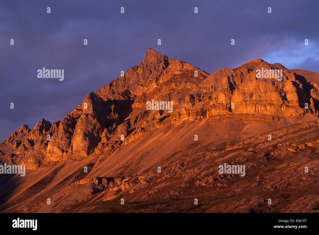 USA Alaska Setting midnight sun lights cliffs above Atigun River Canyon ...