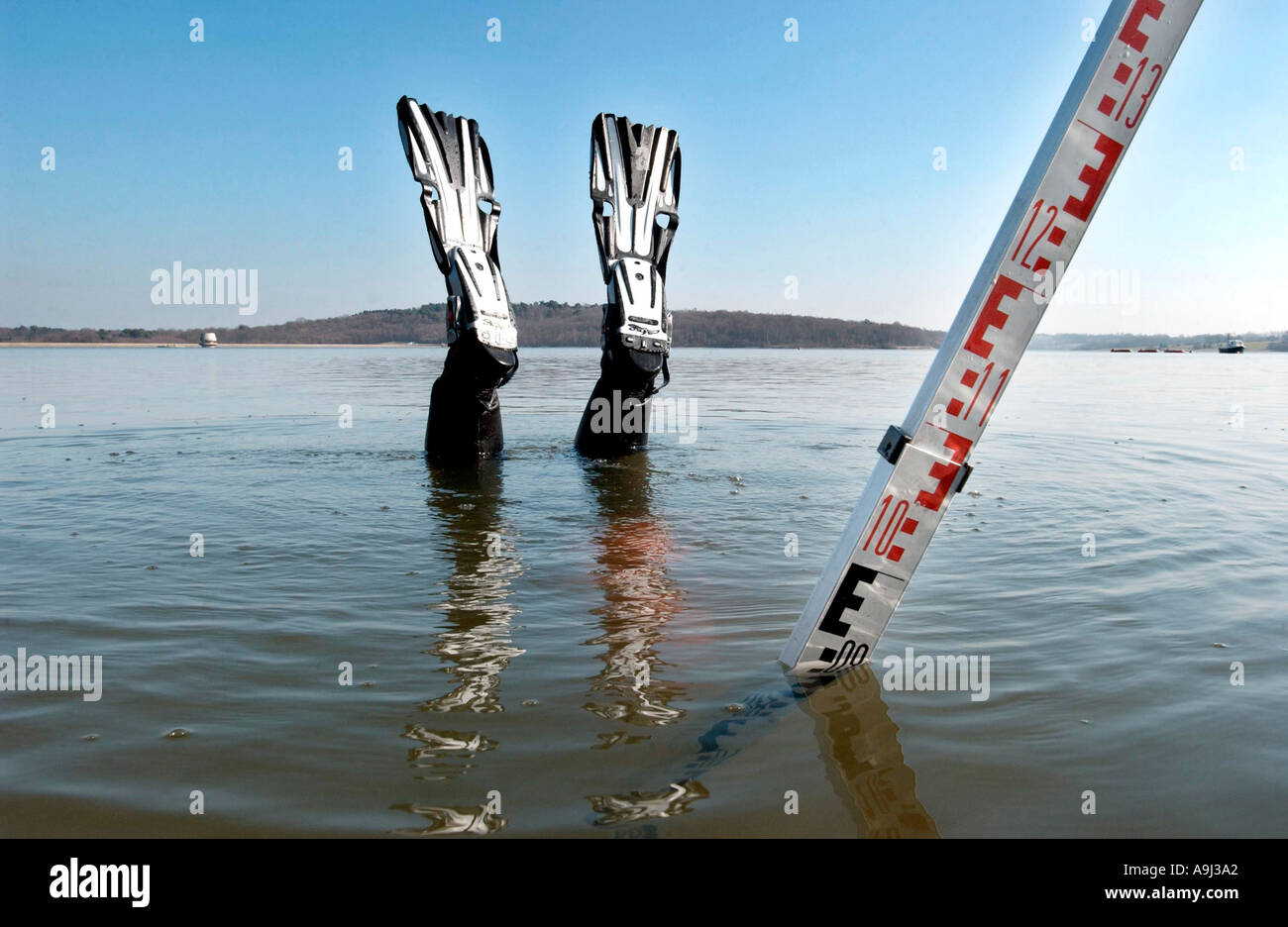 Diver Paul Jackman uses a depth rod to measure the capacity of a ...