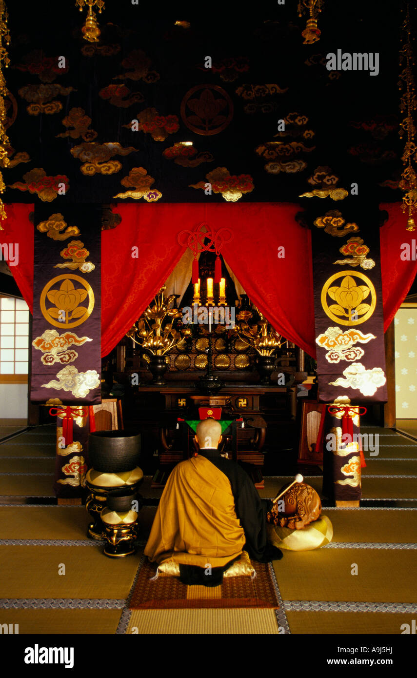 A Zen monk of the Soto School beats a drum in front of the altar at the ...