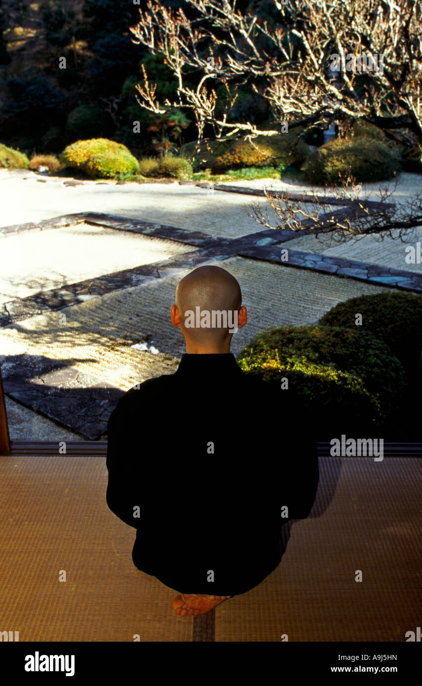 A Zen monk of the Soto School meditates in front of the rock garden at ...