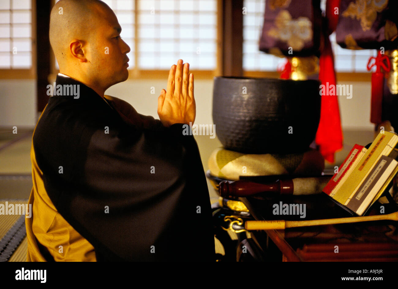 A Zen monk of the Soto School prays in front of an altar at the Seiryu ...