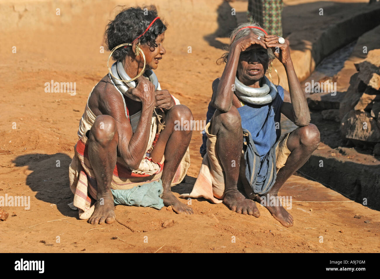 TWO Gadaba tribal women wearing traditonal heavy metal necklets .Orissa ...