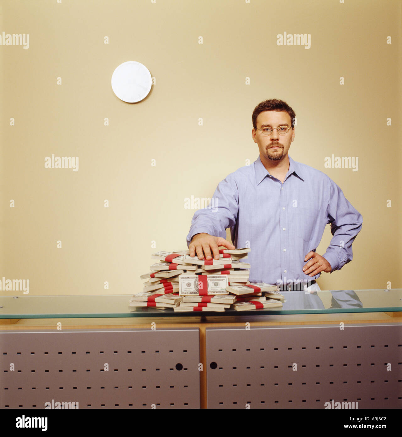 thirty something office worker guarding a tray full of money Stock ...