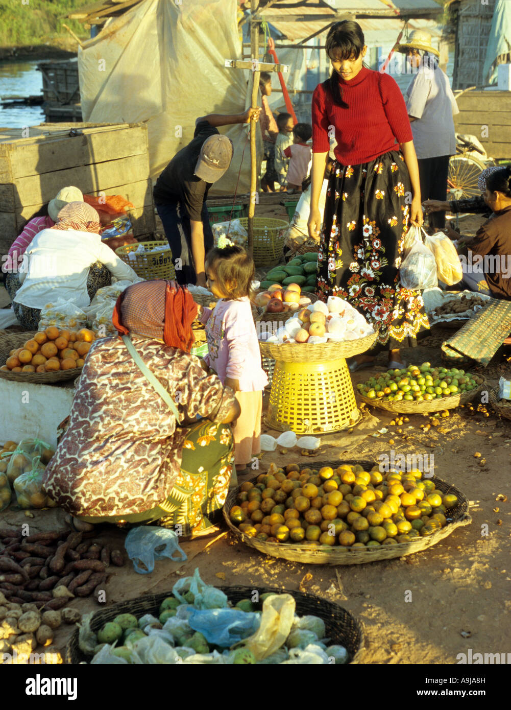 Fruit and vegetable vendors at the early morning roadside market, Chong ...