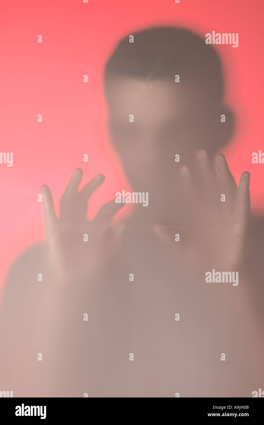 a man hiding behind a red coloured screen Stock Photo - Alamy