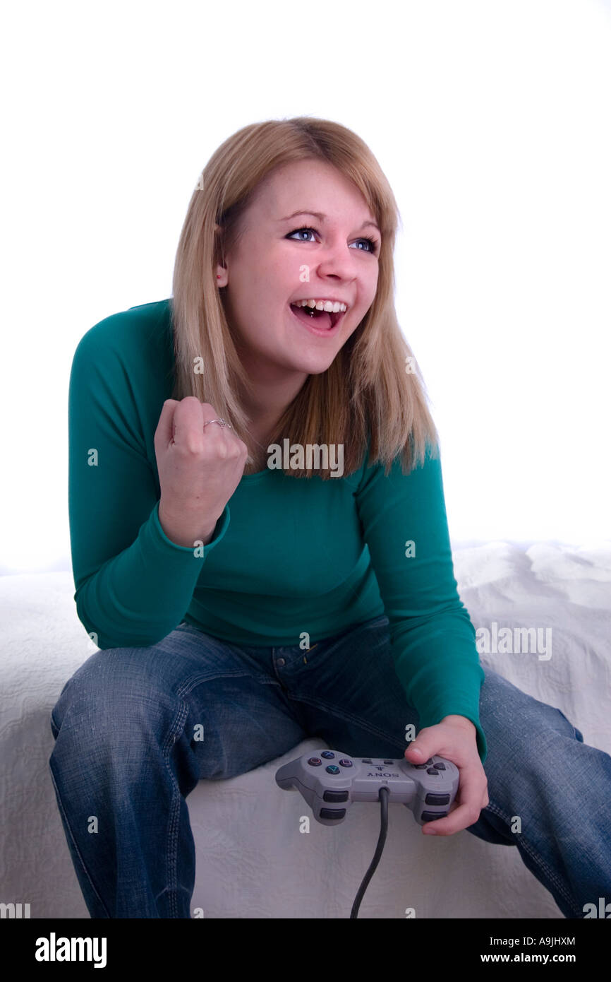 Excited young female using computer game Stock Photo - Alamy