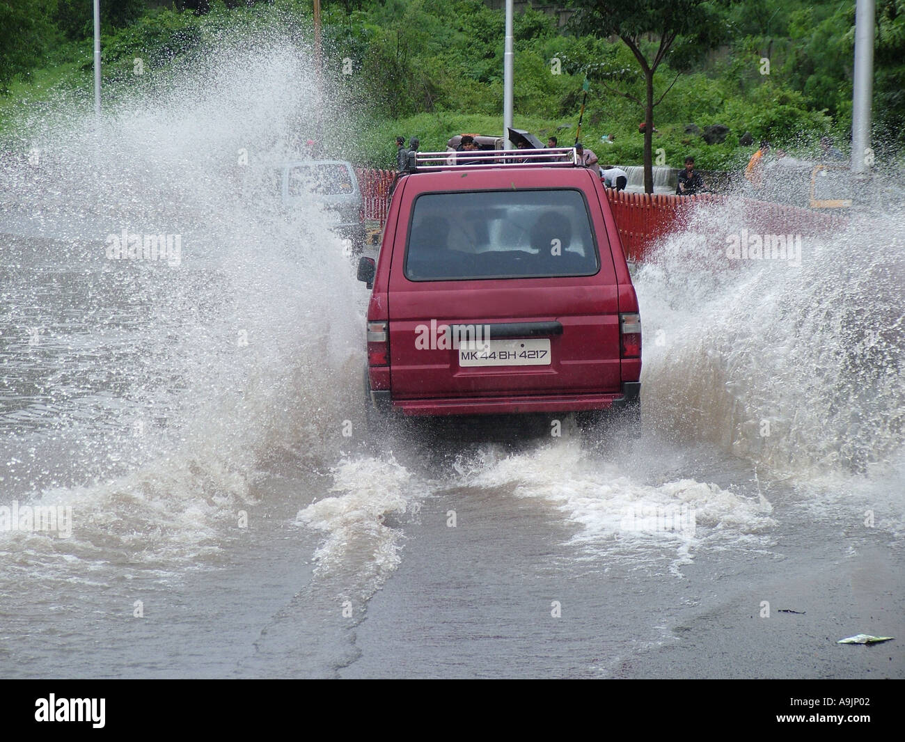 ANG99023 Car splashing monsoon rain water on road india Stock Photo - Alamy