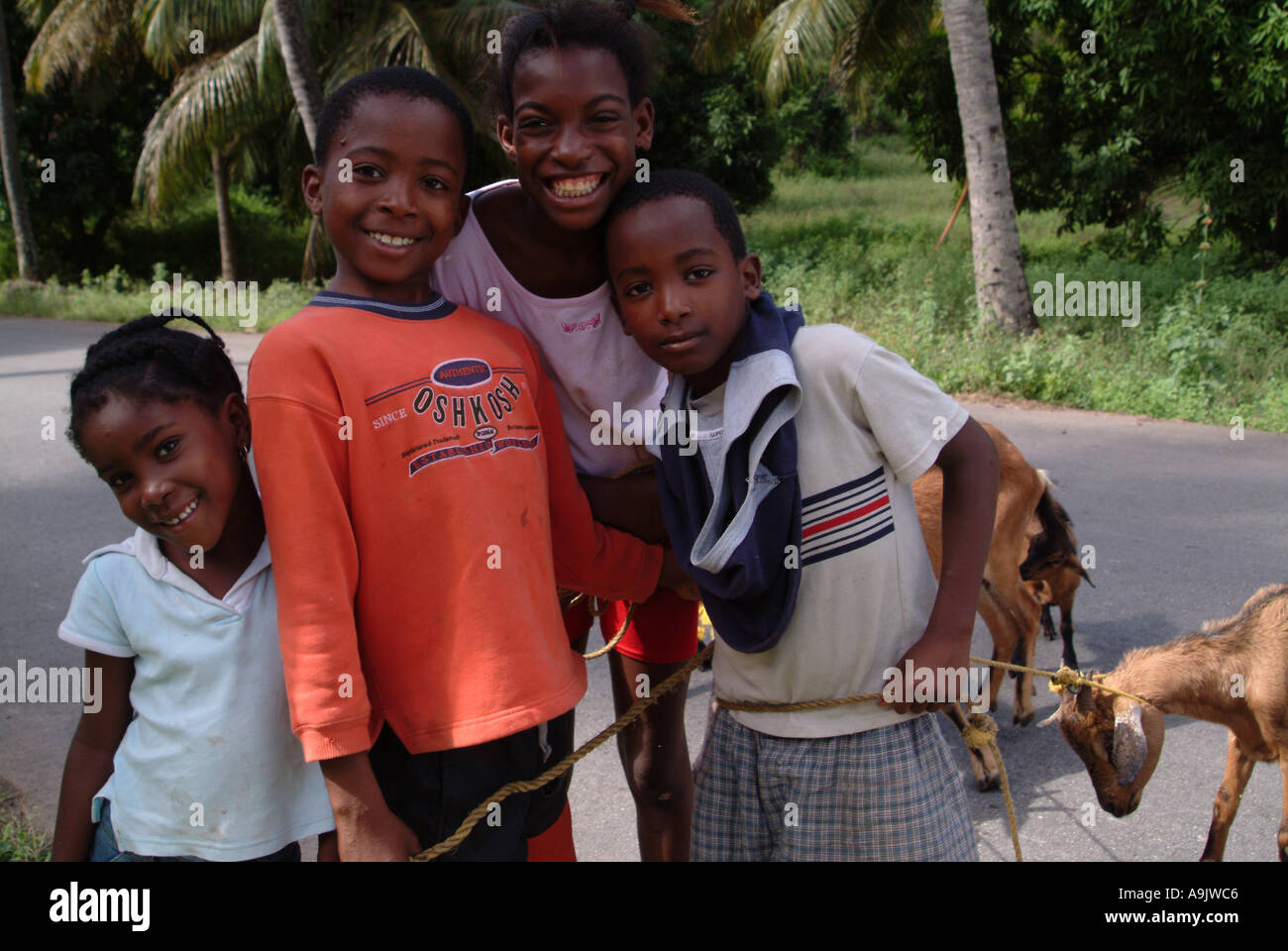 Portrait of children holding goats Stock Photo - Alamy