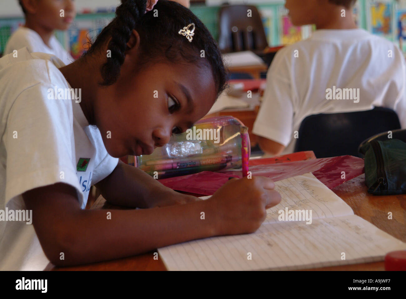 Schoolgirl writing in exercise hi-res stock photography and images - Alamy