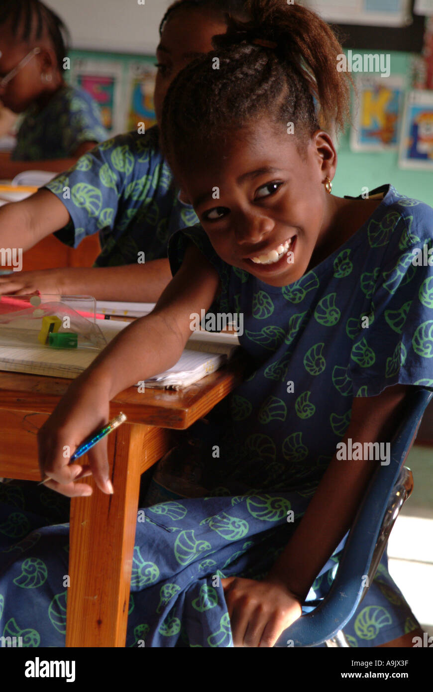 Schoolgirl in classroom laughing Stock Photo - Alamy