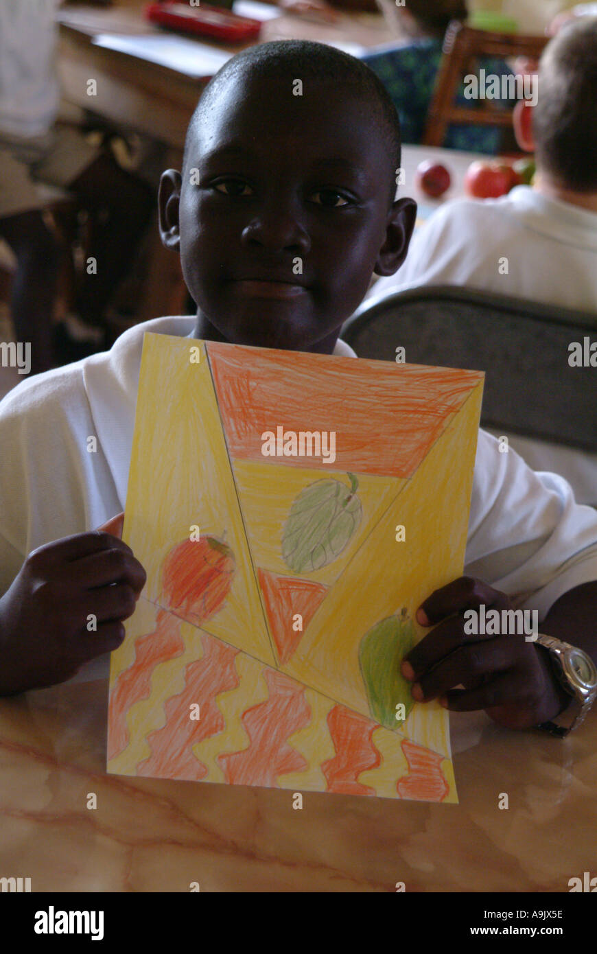 Portrait of a young boy holding a drawing Stock Photo - Alamy