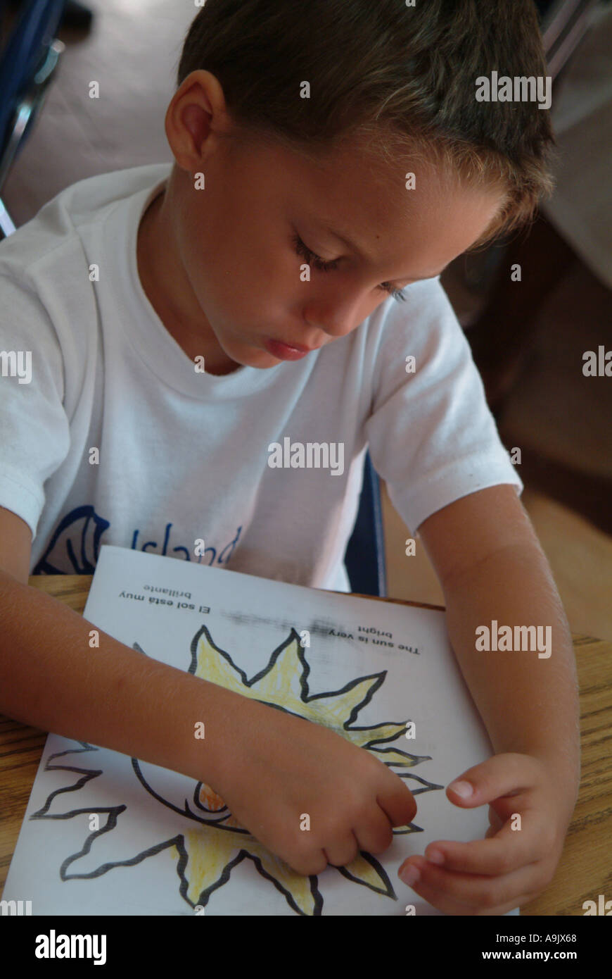 Young boy colouring in with crayons Stock Photo - Alamy