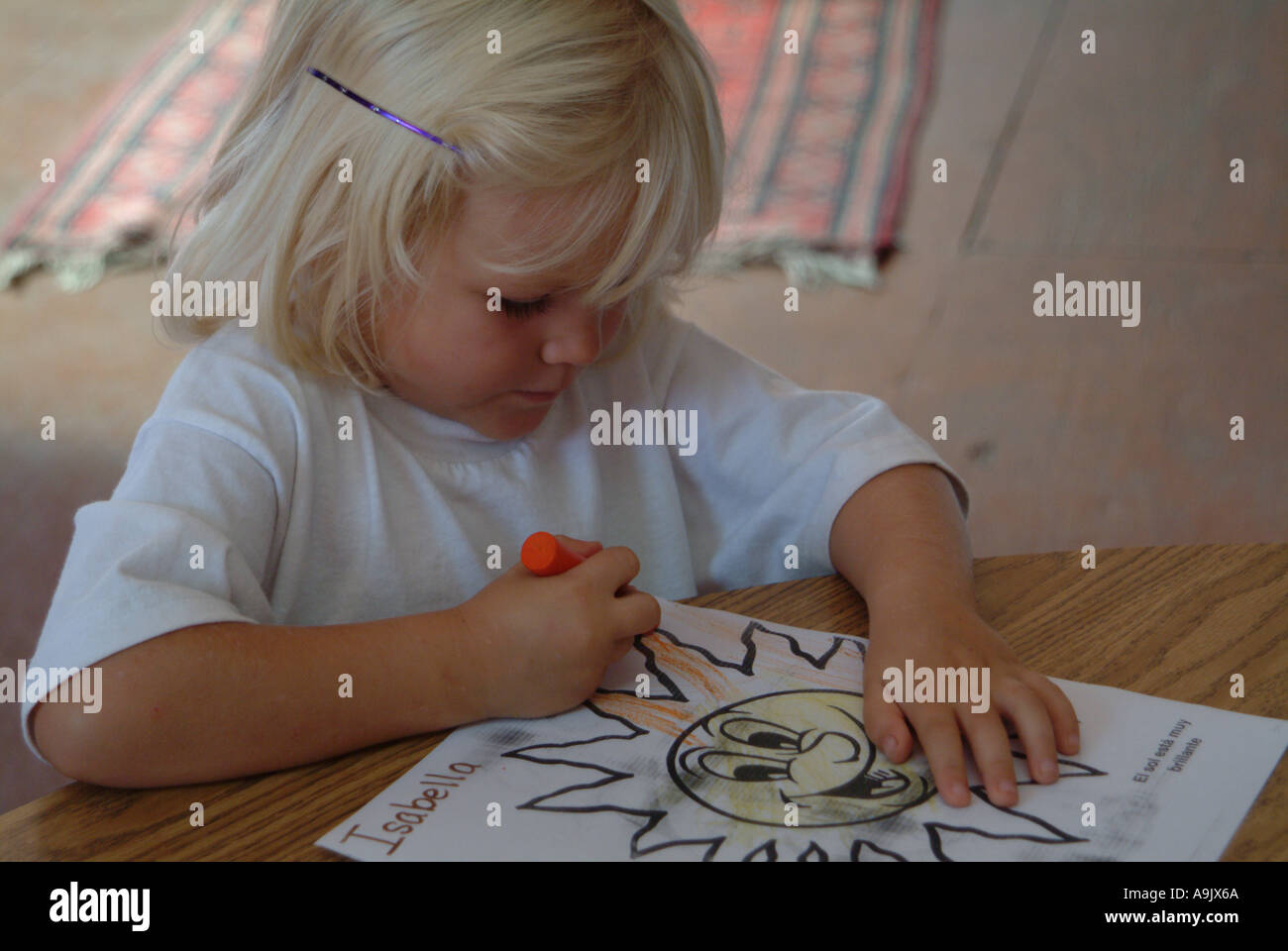 Young girl colouring in with crayons Stock Photo - Alamy