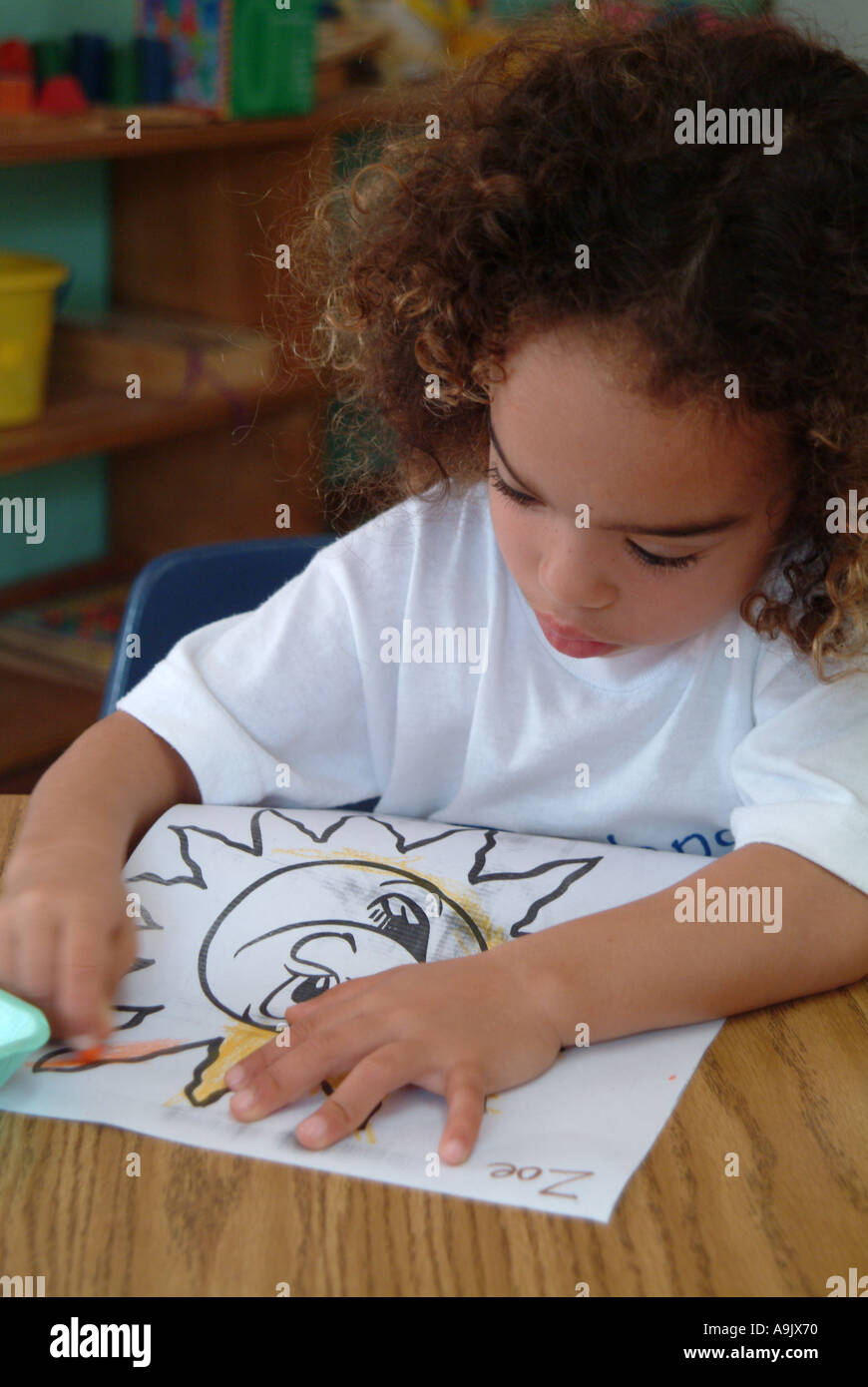 Young girl colouring in with crayons Stock Photo - Alamy
